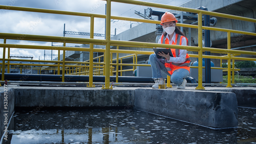 service engineer checking on waste water treatment plant with pump on ...