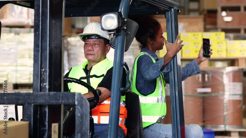 black woman selfie. Warehouse asian male worker staff driving forklift ...