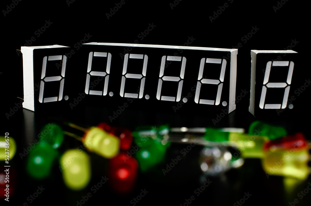 Seven segment indicators on a black background with colorful LED diodes ...