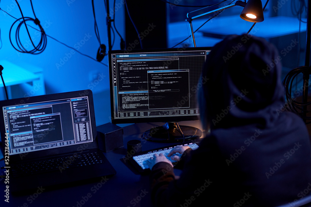 cybercrime, hacking and technology concept - female hacker in dark room ...