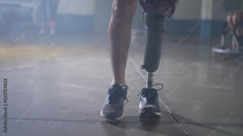Disabled person walking with his prosthetic leg indoors. Amputee man ...
