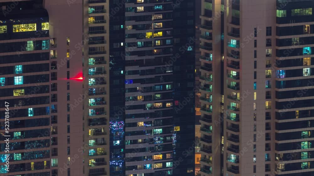 Windows in high-rise building exterior in the late evening with glowing ...
