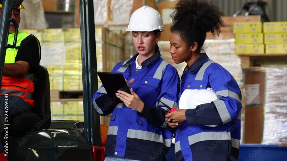 warehouse manager. Warehouse manager and staff driving forklift ...