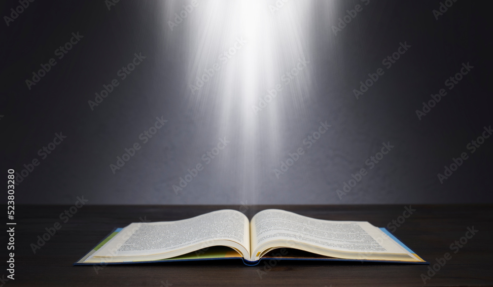 Open Bible. Holy Bible on the table. Light from a book. Stock Photo ...