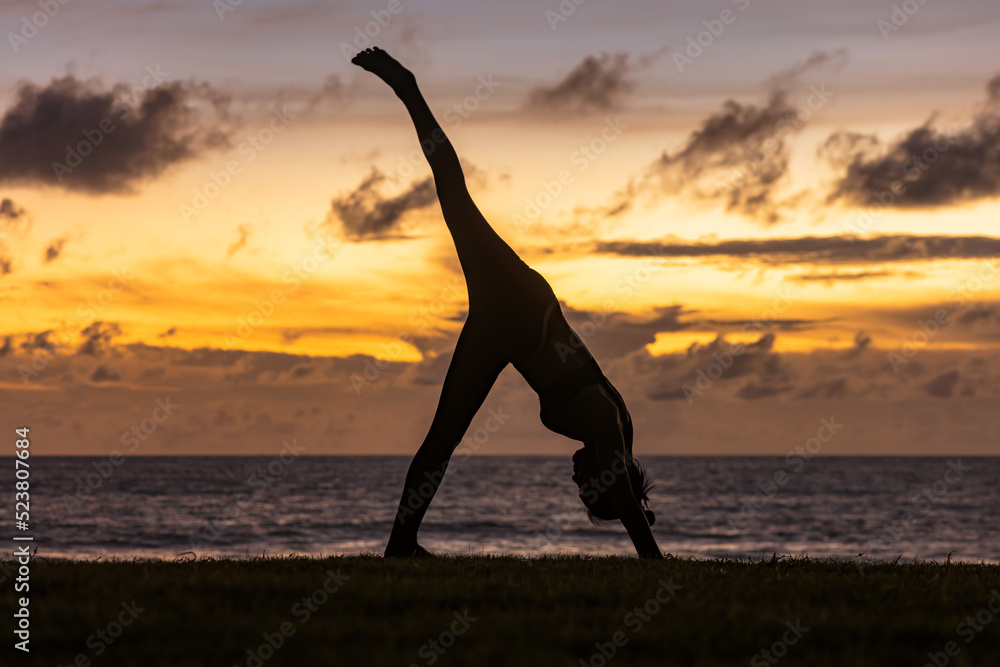 Silhouette fitness woman excising during sunset at Phuket beach, Yoga ...