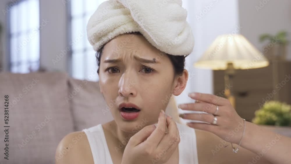 headshot frowning asian lady looking at camera mirror reflection with ...