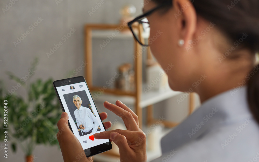 Finding love. Woman who is looking for love scrolls through profiles of ...