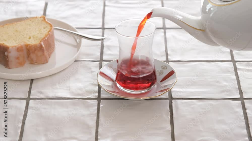 pouring Turkish tea in a modern Turkish glass Stock ビデオ | Adobe Stock