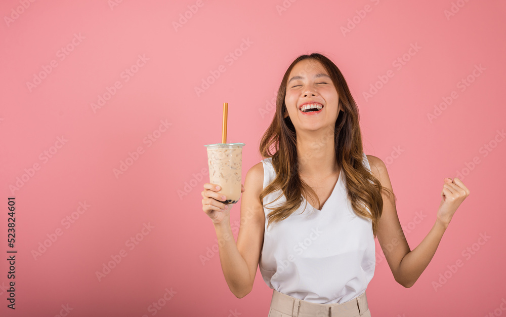 Excited Asian beautiful woman holding drinking brown sugar flavored ...
