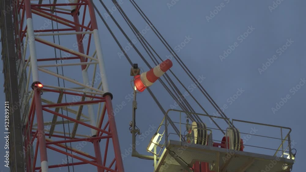 Windsock on crane. Crane boom and cables. Loading safety. Wind ...