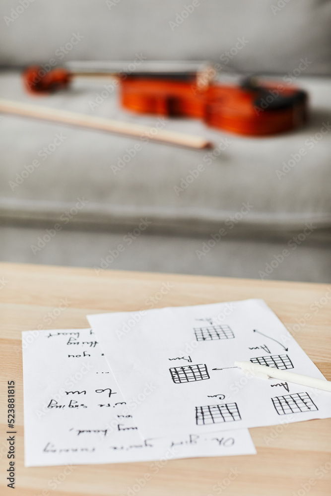 Vertical background image of music composition sheets on table in home ...