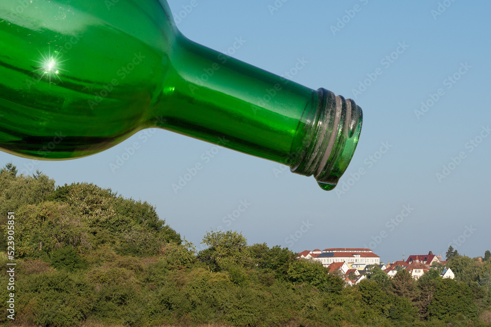 An empty water bottle over the thirsty city. When water becomes scarce ...