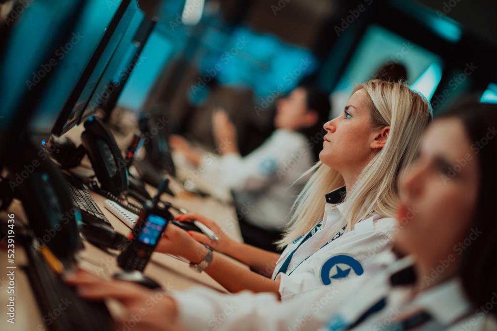Female security operator working in a data system control room offices ...