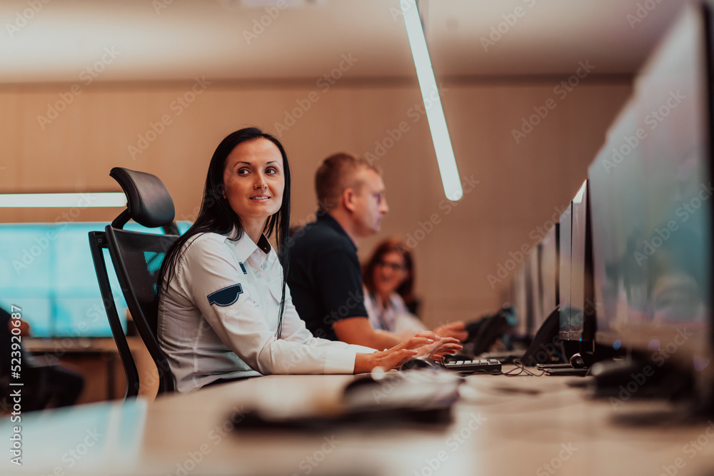 Female security operator working in a data system control room offices ...