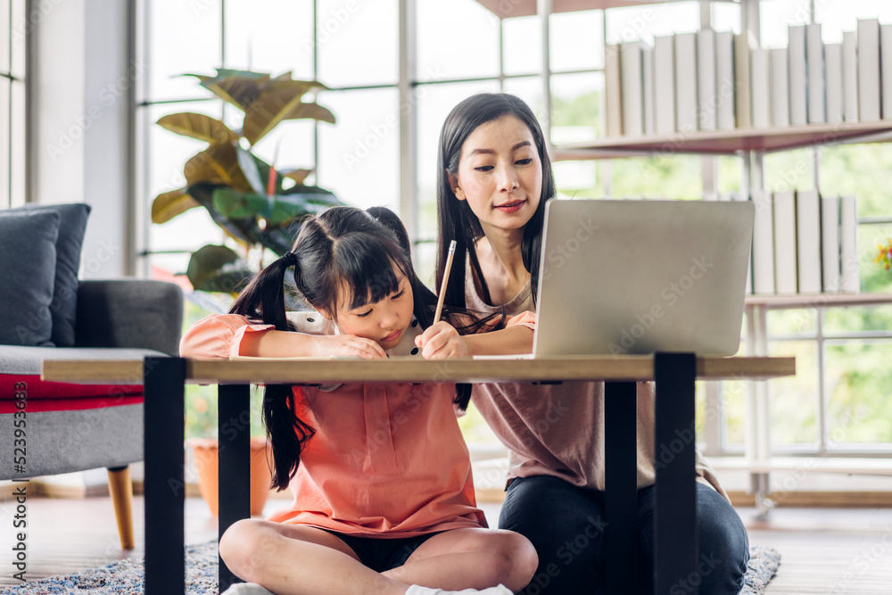 Mother and asian kid little girl learn and look at laptop computer ...