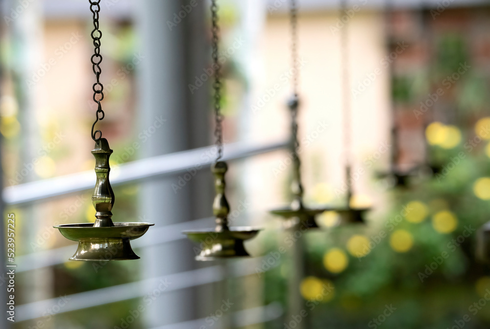 Traditional Kerala Onam and Diwali lamps hanging one besides the other ...