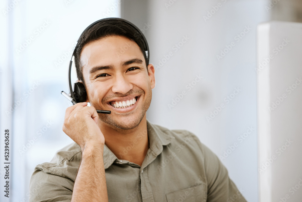 Smiling, friendly call center agent with headset for online consulting ...