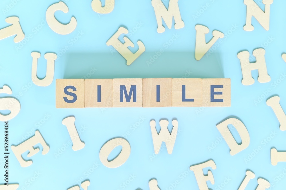 Simile figure of speech concept in English grammar class lesson. Wooden ...