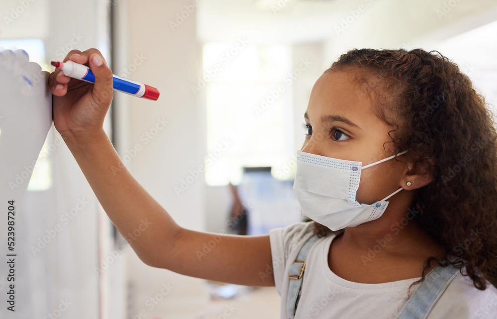 School student writing on whiteboard in class during covid pandemic for ...