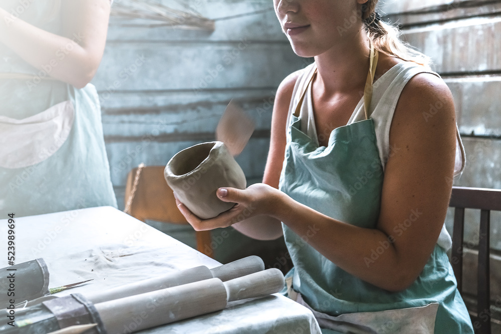 Potter makes dishes from clay, ceramics.Craft,work by hand in the ...