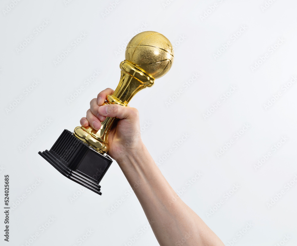 Hand holding golden basketball trophy on white background Stock Photo ...