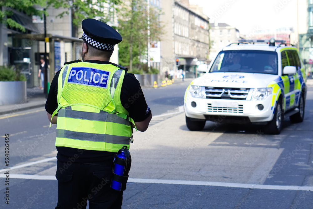 Police officer on duty on a city centre street during special event ...