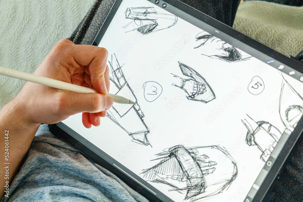 Artist creating his digital drawing on the tablet using digital pen ...