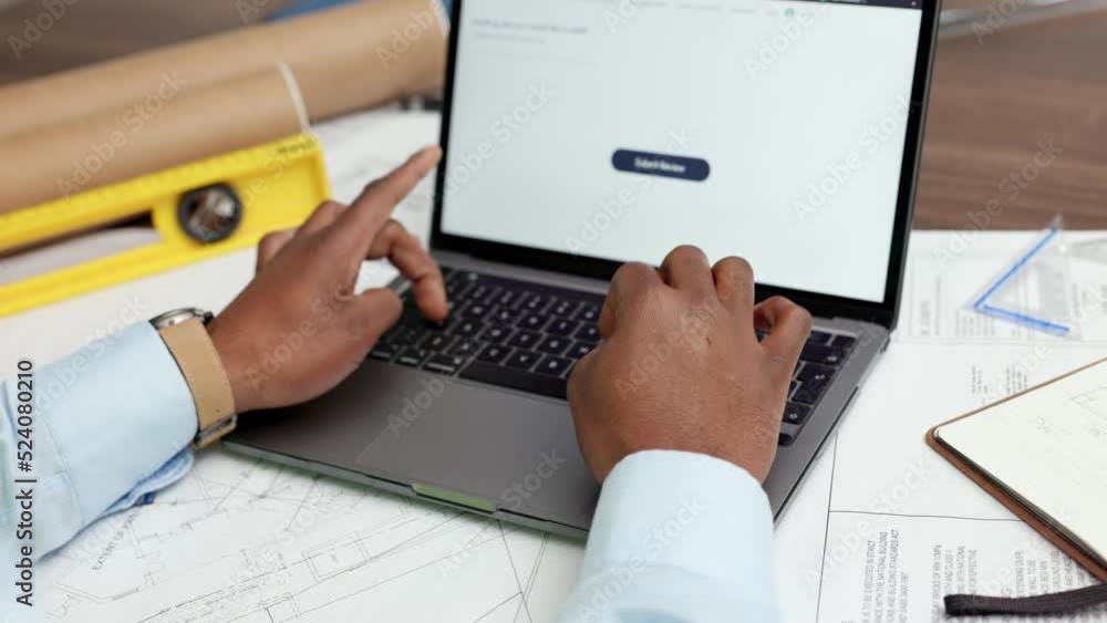 Engineer designing a blueprint on a laptop, typing design ideas and ...