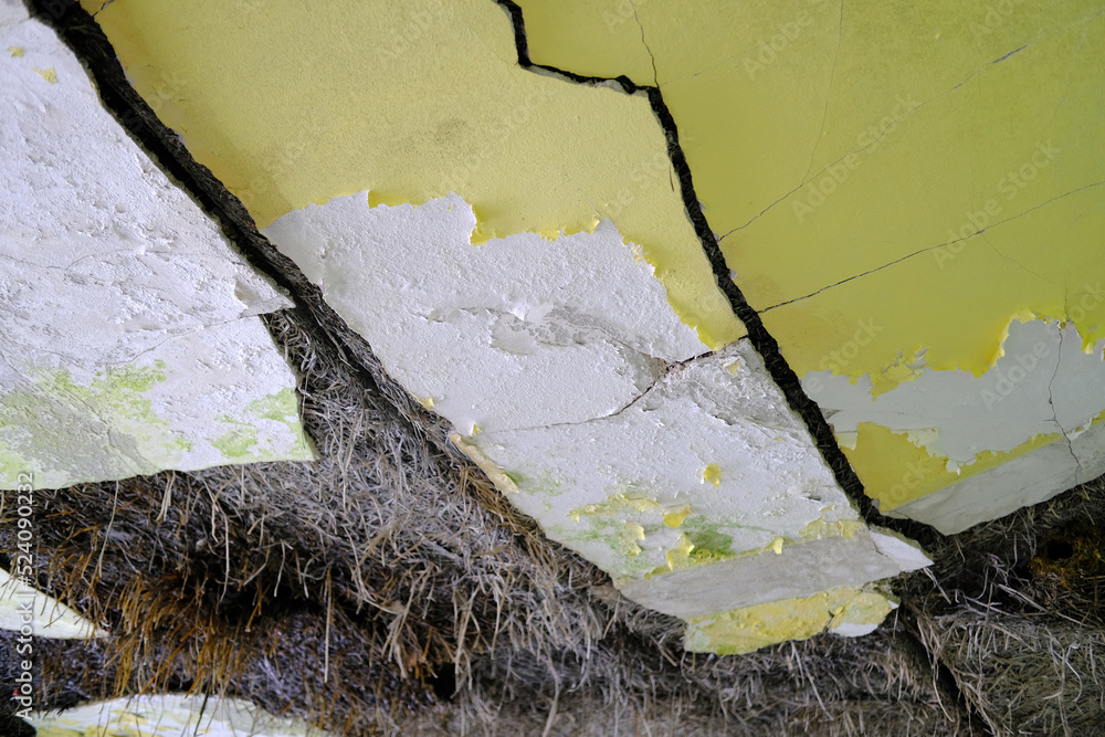 collapsing house with collapsed ceiling, cracks, concept of destruction ...