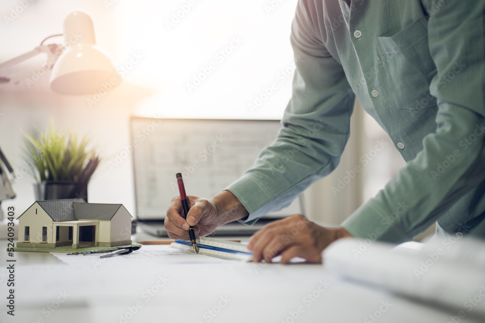 Architect Design Concept, Asian engineer work on use scale ruler with ...