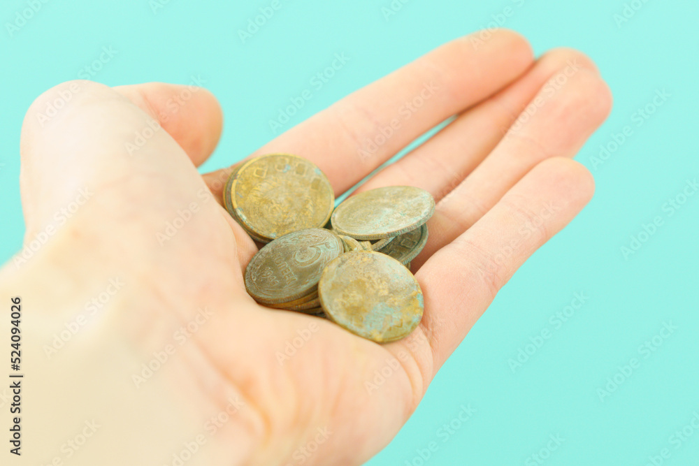Man's hand holding a heap of dirty oxidated old 5 coins of the Soviet ...