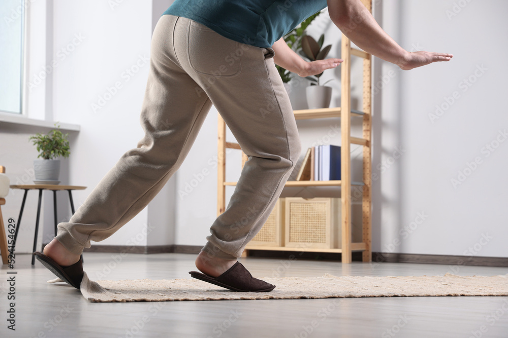 Man tripping over rug at home, closeup Stock Photo | Adobe Stock