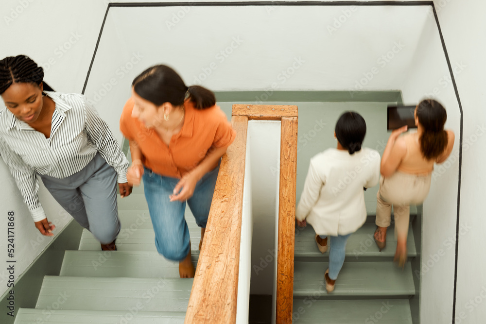 Overhead of busy, diverse female colleagues returning to work after ...