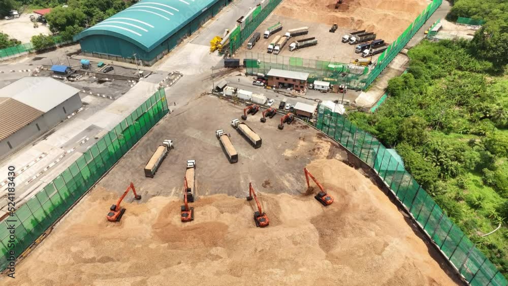 Aerial top view of wood chips with backhoe working load unload chip to ...