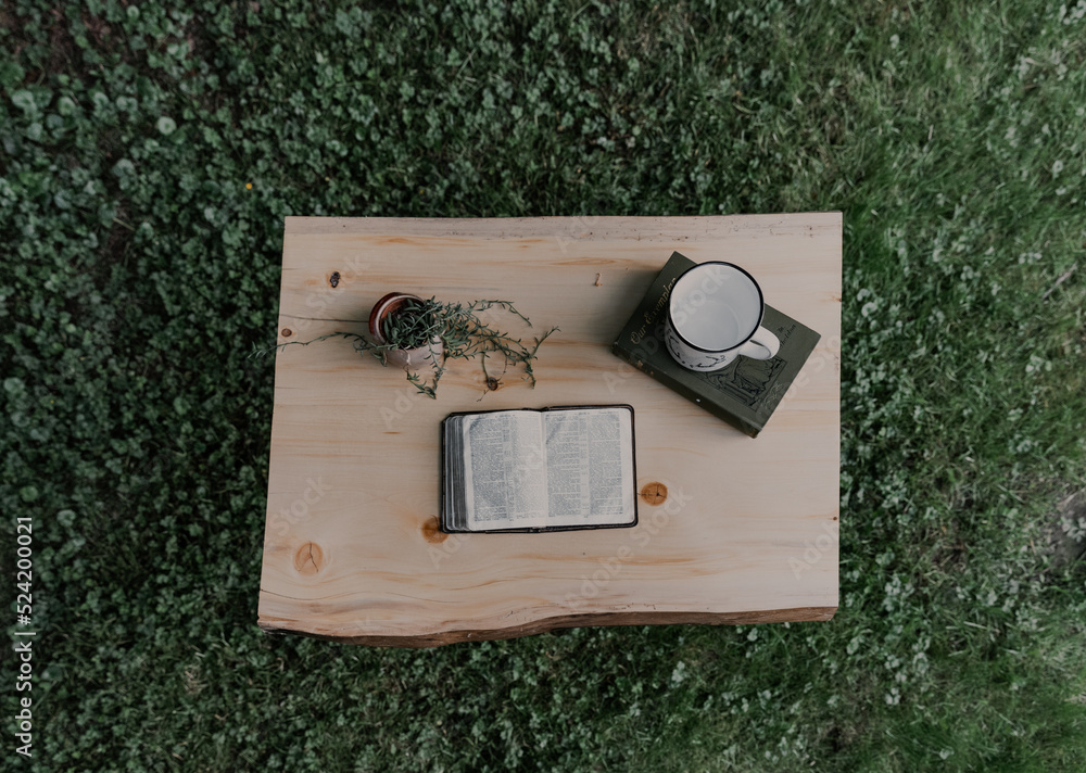 An open Christian Holy Bible scripture on a handmade wooden table with ...