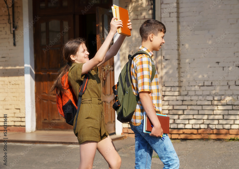 schoolchildren are having fun in the school yard - a teenage girl wants ...