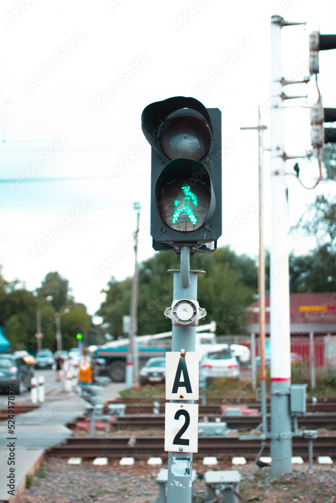 Traffic light with green man allowing railroad crossing, safe ...