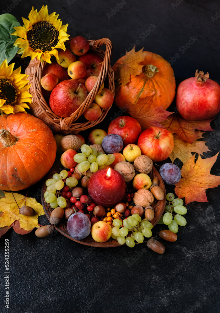 Candle, fruits, pumpkins, flowers on abstract black background. fall ...