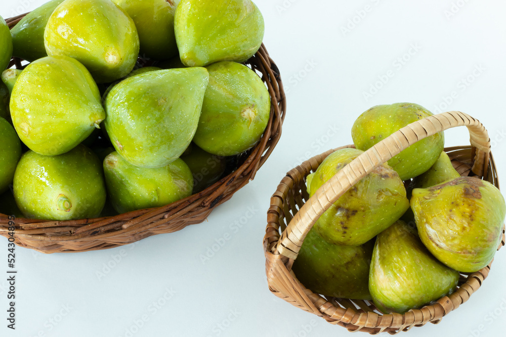 Ripe figs in two wicker baskets isolated on a white background. Good ...
