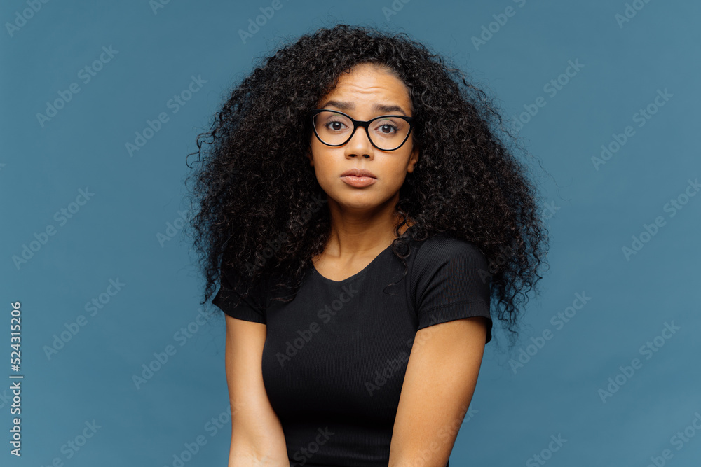 Photo of indignant puzzled Afro American woman looks surprisingly at ...