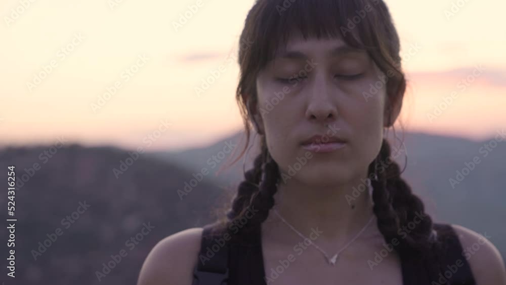 Young Native American woman takes a deep breath with her eyes closed ...