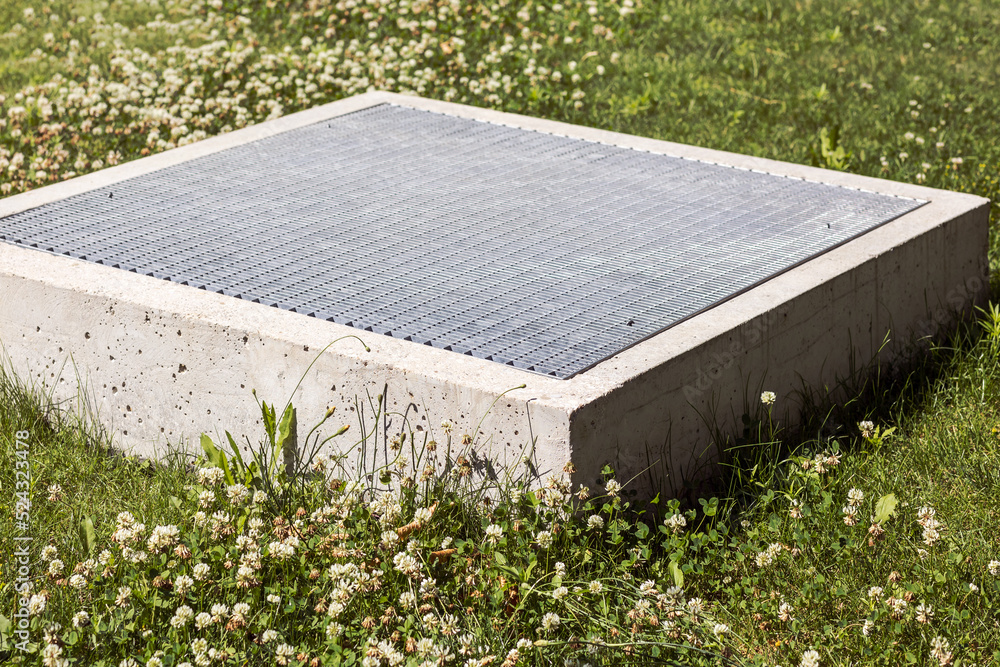 Ventilation shaft Outlet with metal grid on Ground Green Lawn. Modern ...