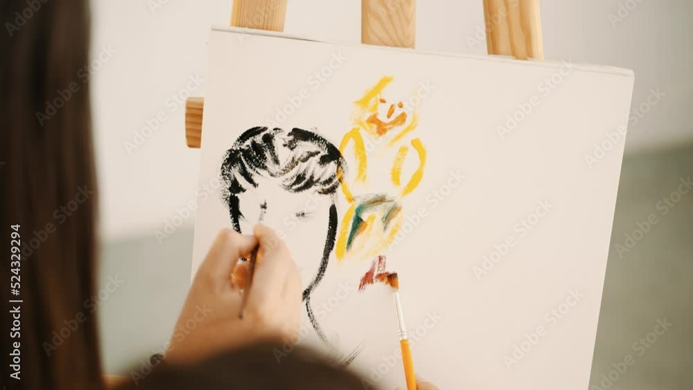 Drawing with two hands. Couple is drawing picture. Man and woman make ...