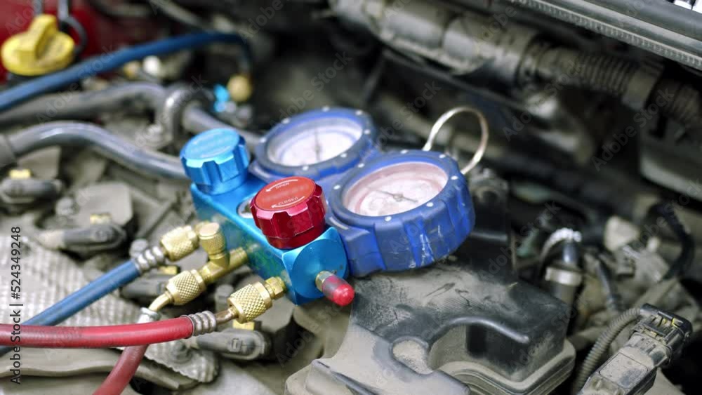 Under hood of open car lies system of manometers for refueling air ...