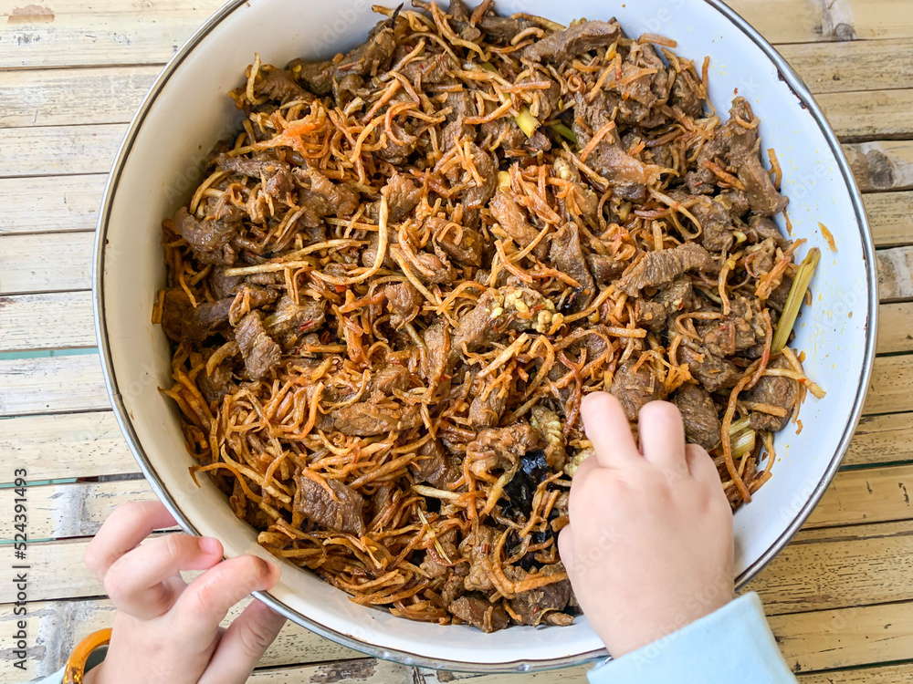 Hands holding bowl of Sambal Goreng Daging (Gore Gore) cuisine from ...
