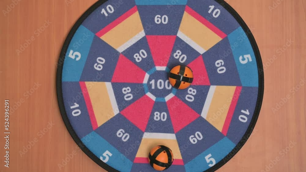 Footage shows a target ball game attached to a wooden closet and balls ...