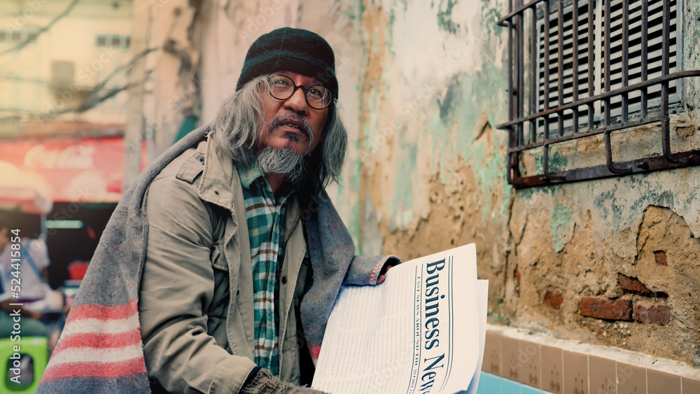 Asian homeless people standing like a newspaper in the corner of an old ...