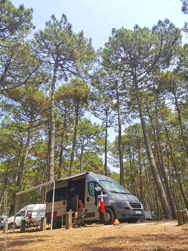 camper van in a forest camp site. Stock Photo | Adobe Stock