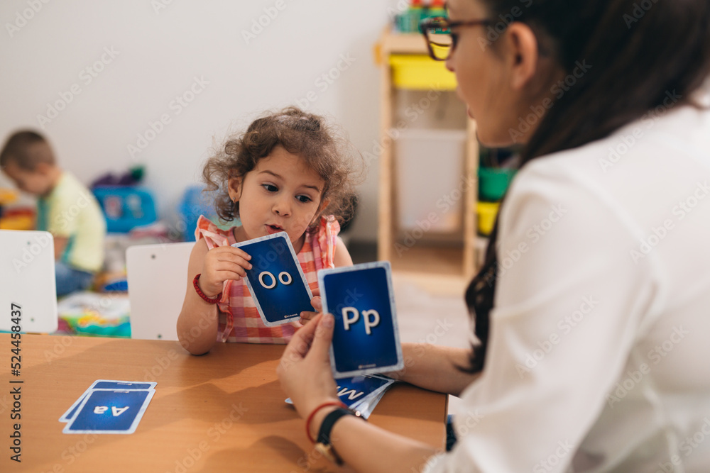teacher teaching child to correct pronouncing the words at child ...