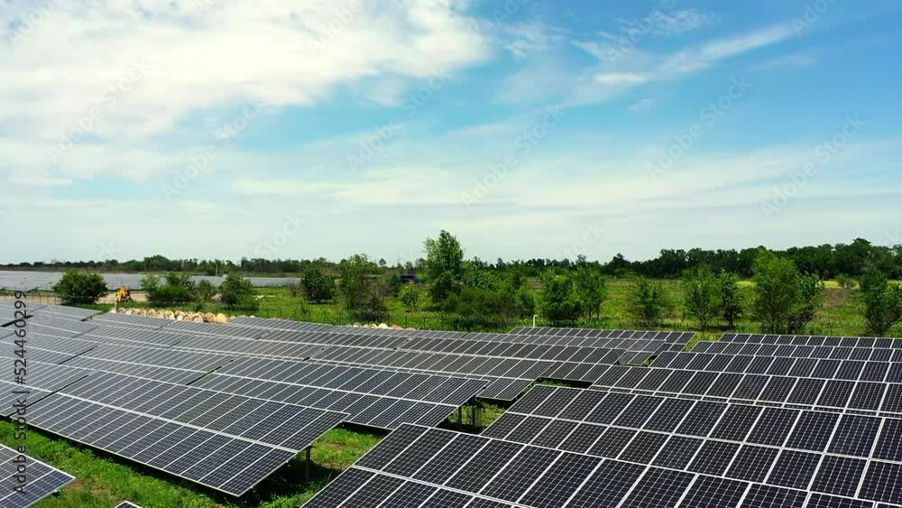Amazing bird's eye view of solar panels standing in a row in the fields ...